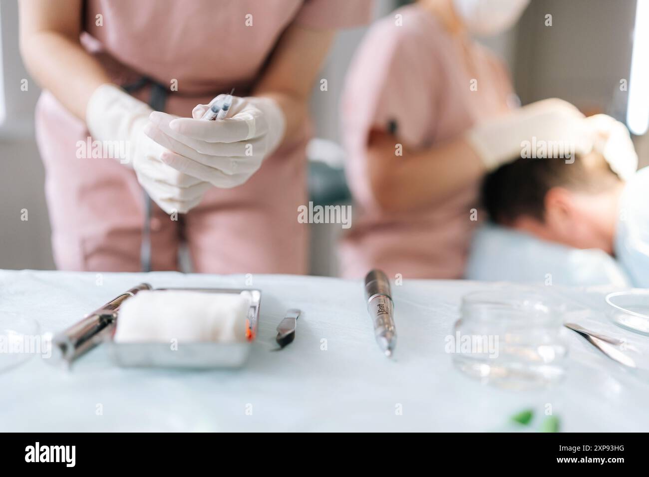 Medical professional uncapping syringe needle hi-res stock photography ...
