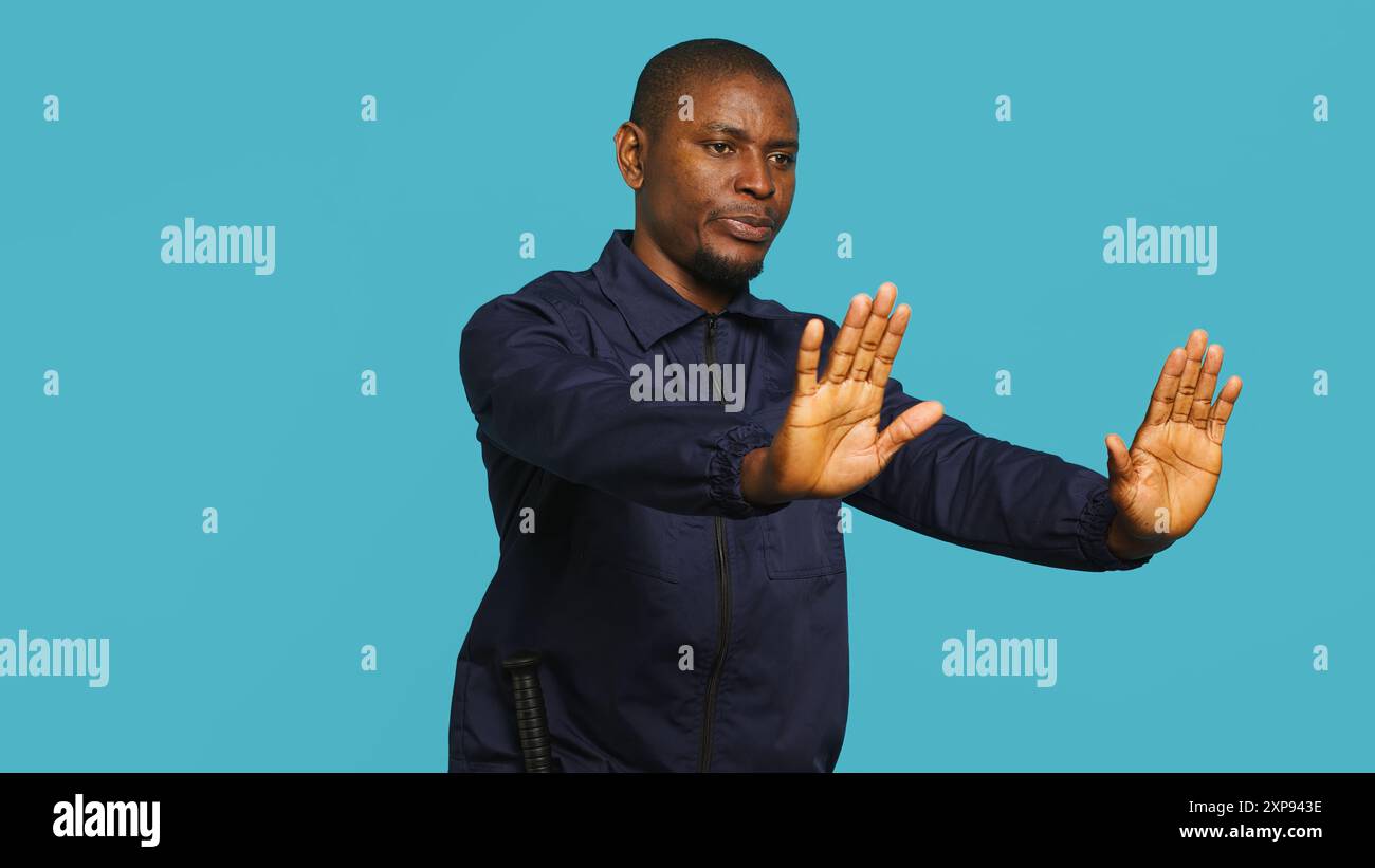 Portrait of security agent doing crowd control, securing assigned post ...