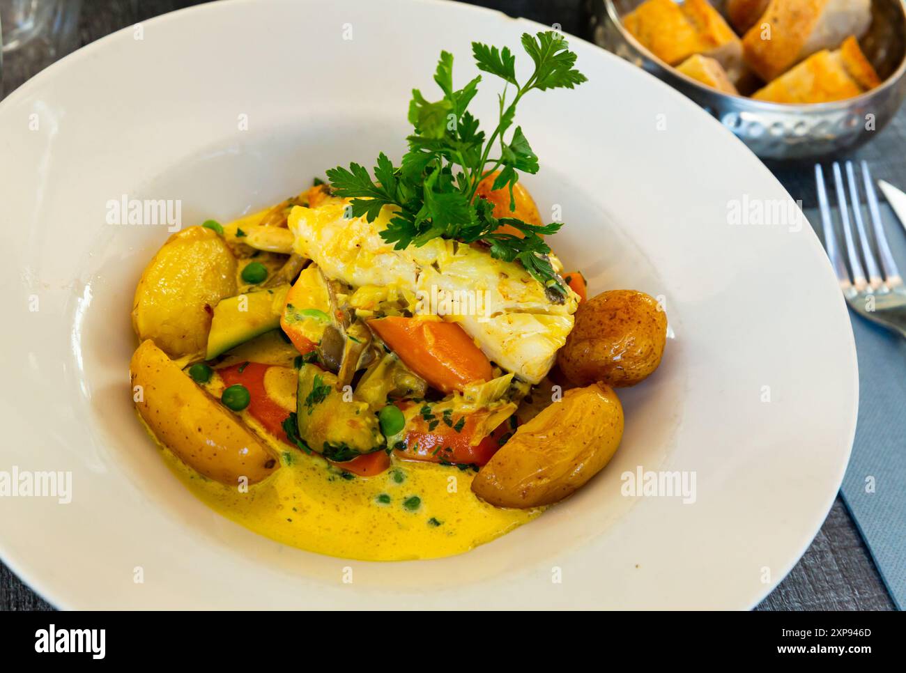 Hake fillet in Spanish style Stock Photo - Alamy