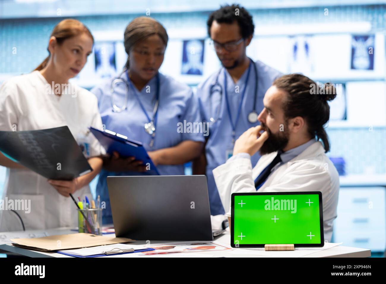 Diverse team of specialists examining radiography test scans with ...