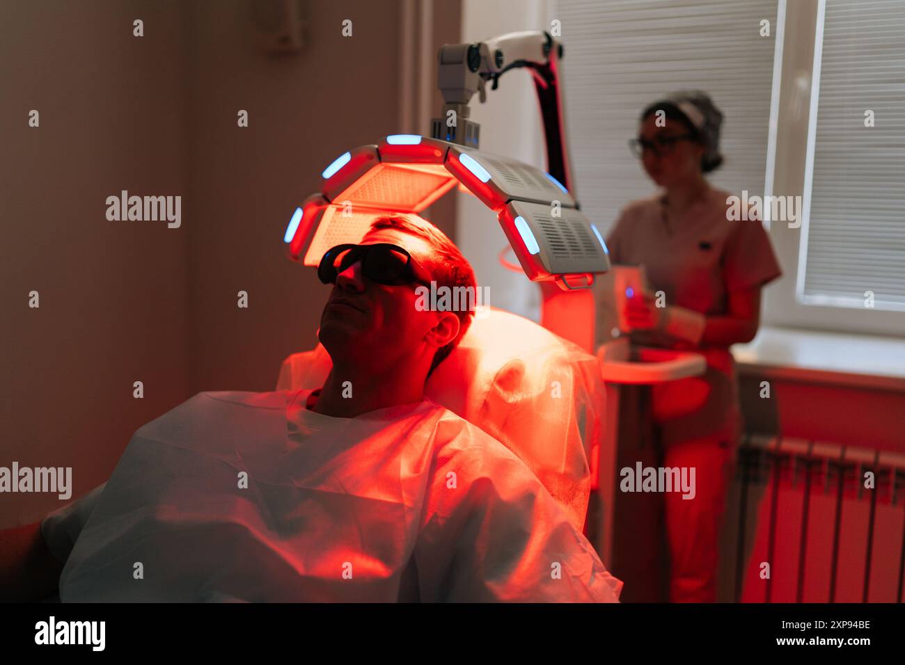 Trichologist specialist adjusting innovation device for photodynamic ...