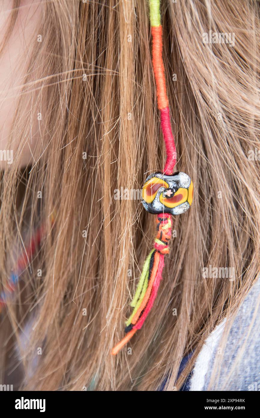 Hair braiding. Decorative ornament and colorful string braided in Stock ...