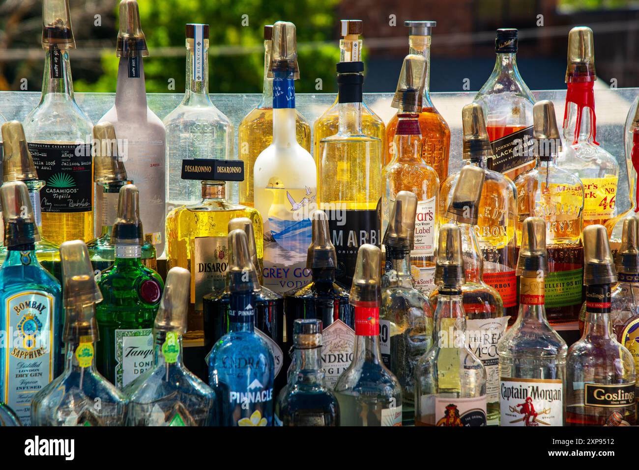Liquor bottles lined up on a roof top bar overlooking the fourth of ...