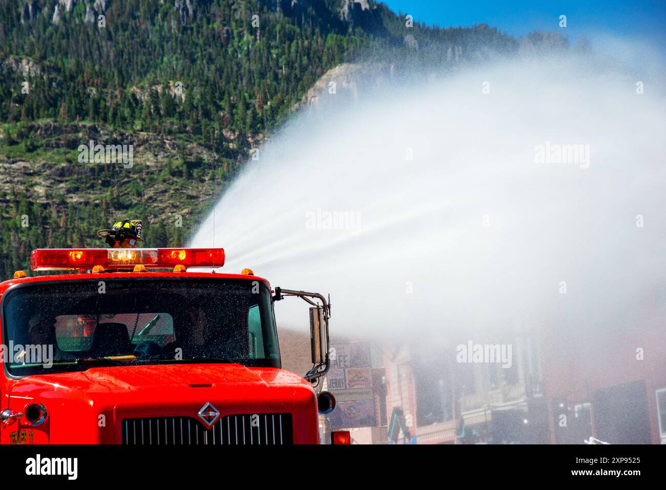 The local fire department uses their water canyon to spray participants ...