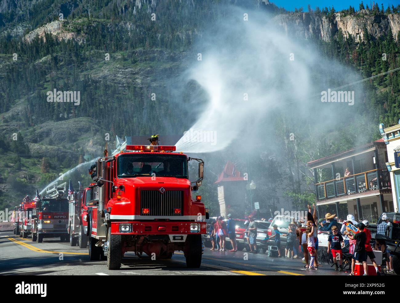 The local fire department uses their water canyon to spray participants ...