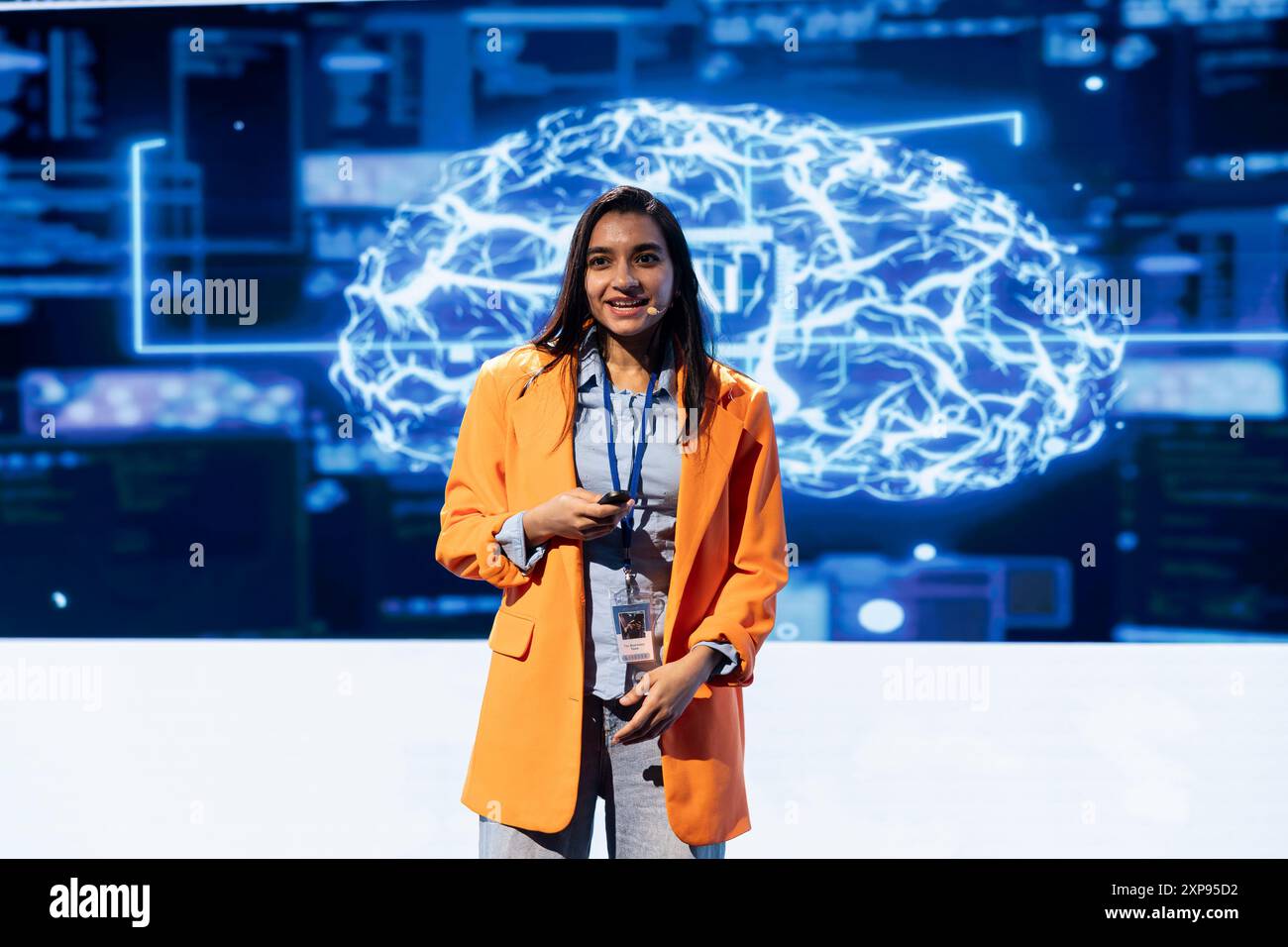 Smiling presenter talking at AI summit using mic, sharing industry ...