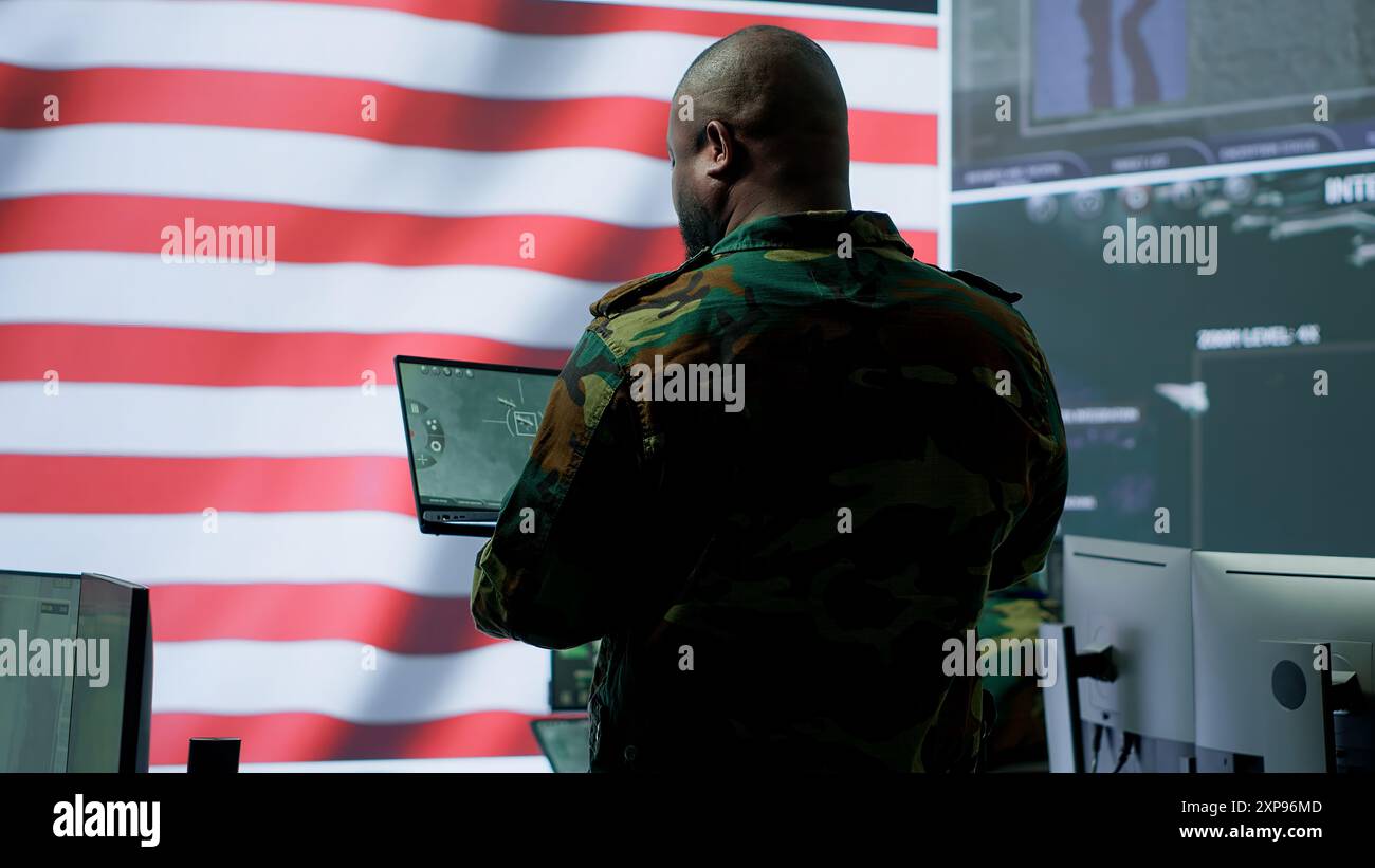 Team of military experts operates high tech computers and tablet to ...