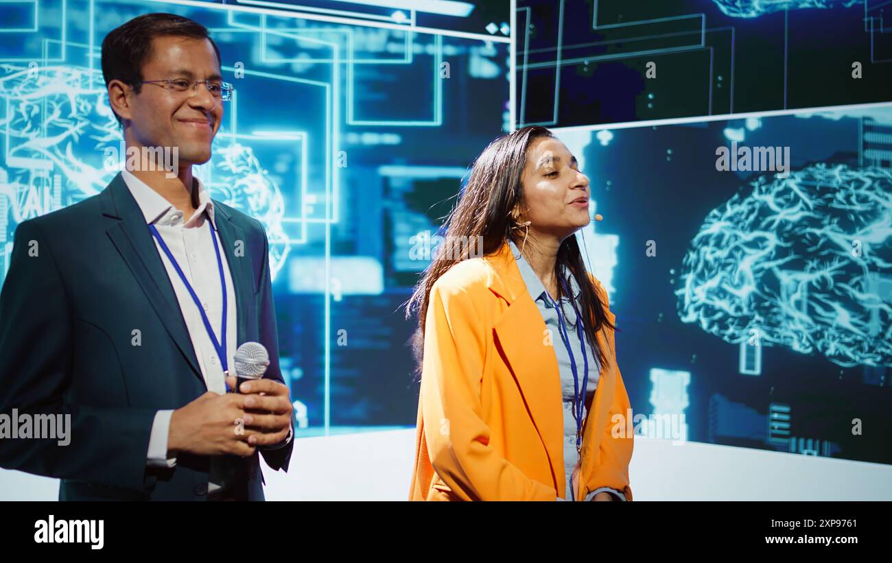 Cheerful host and expert guest talking at AI summit bringing together ...