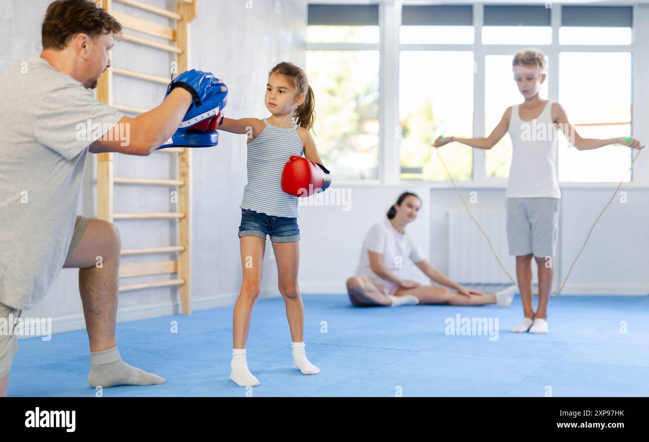 Father and daughter training boxing in studio Stock Photo - Alamy