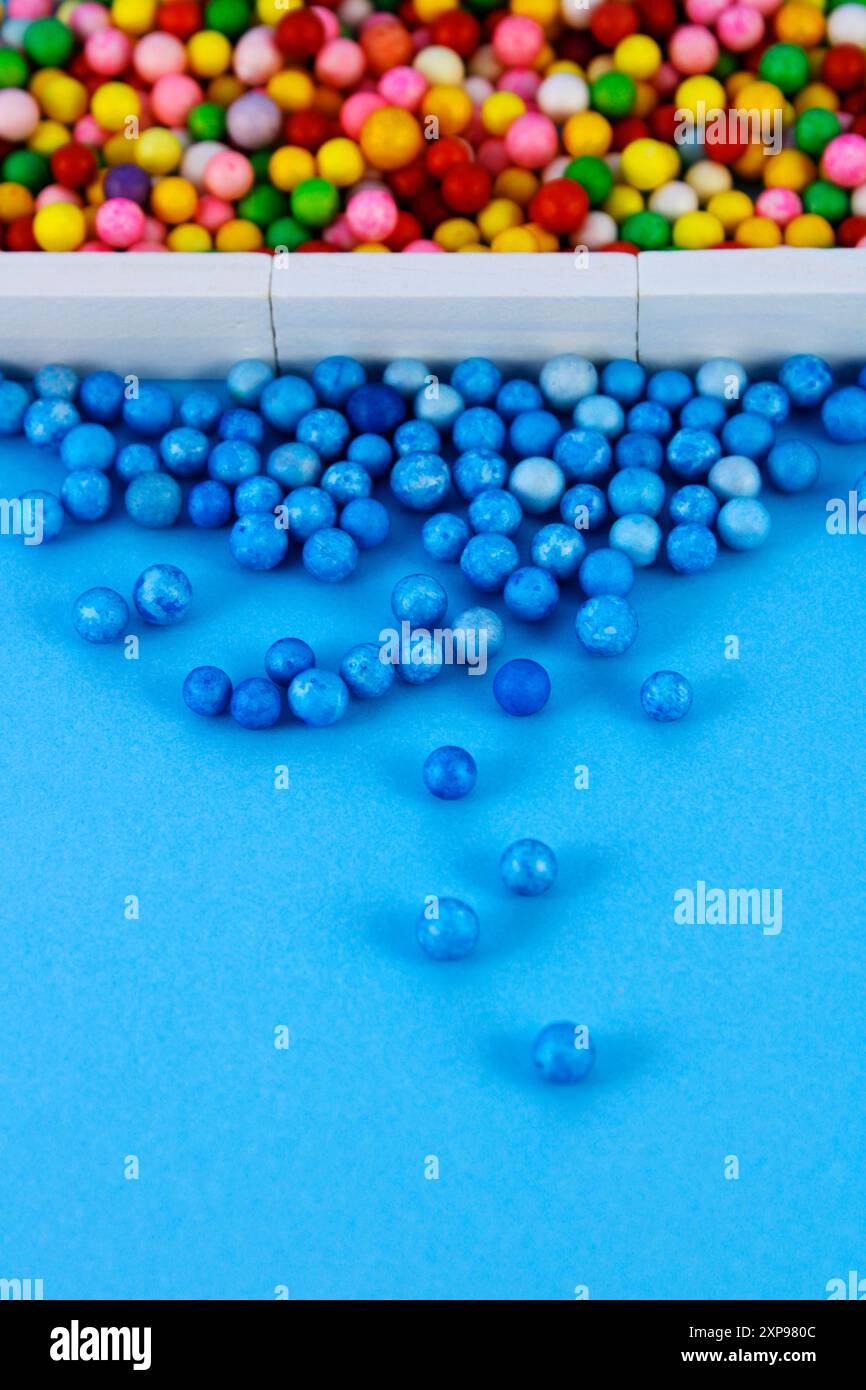 Blue spheres separated from other spheres of different colors by a wall ...