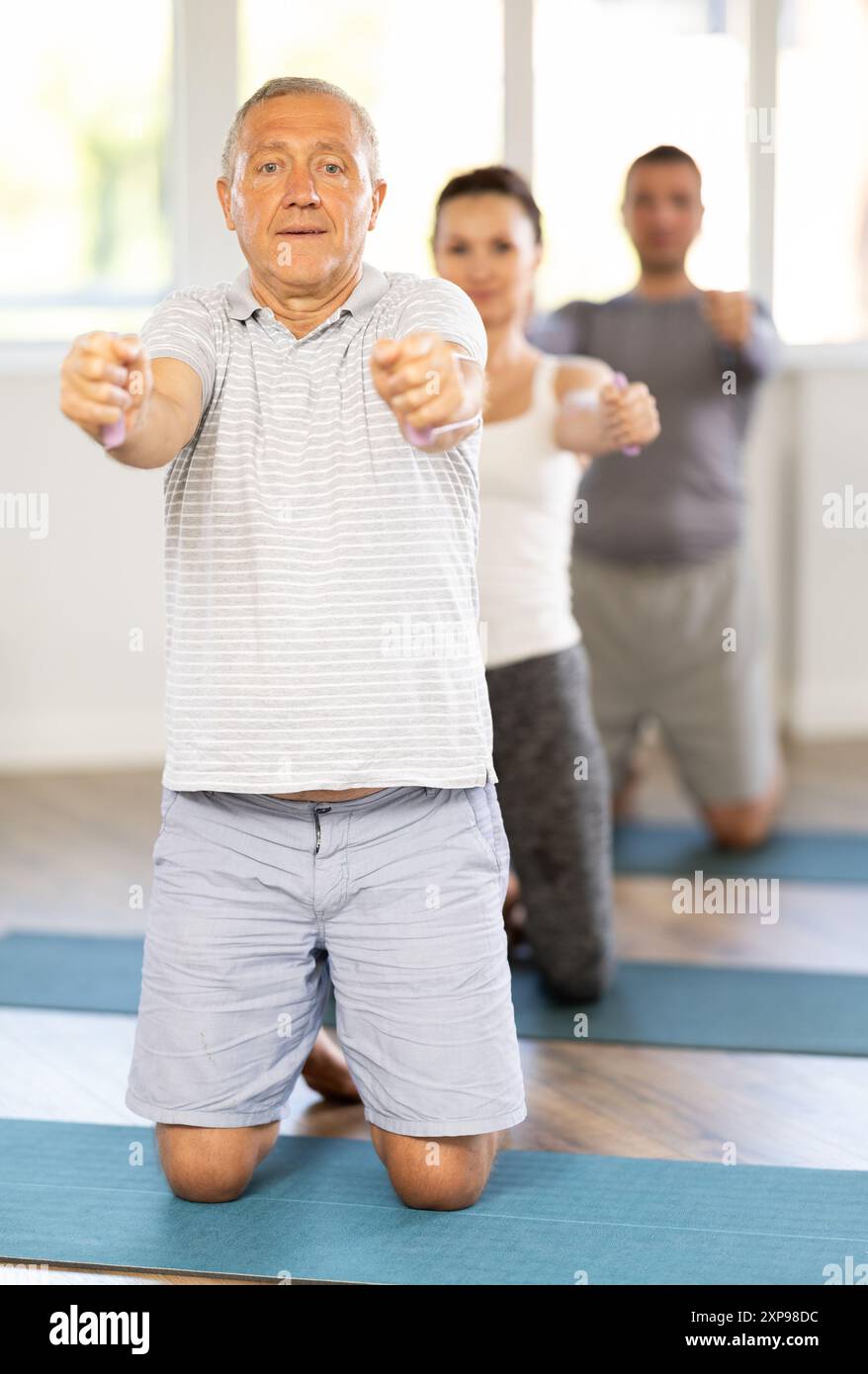 Mature man bring together and spread your straightened arms at chest ...