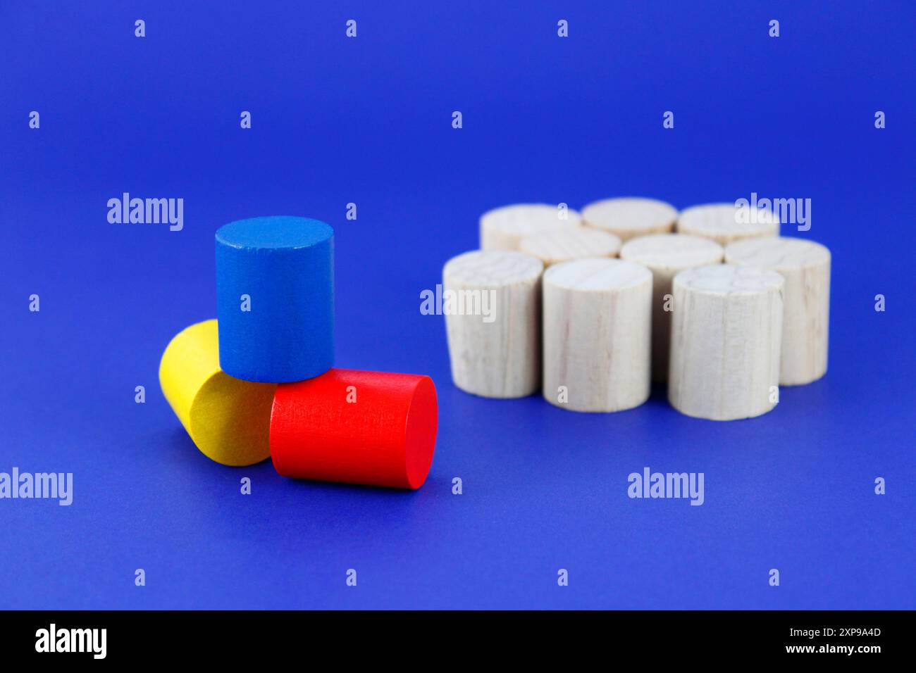 Wooden cylinders where three of them are differentiated by color and ...