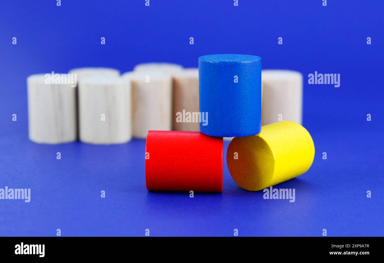 Wooden cylinders with primary colors that are differentiated from the ...