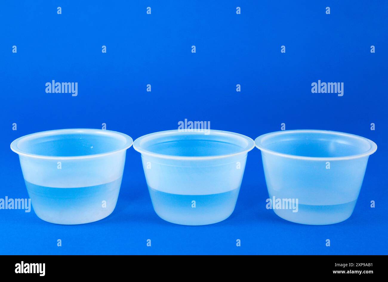 Plastic containers with various levels of water Stock Photo - Alamy