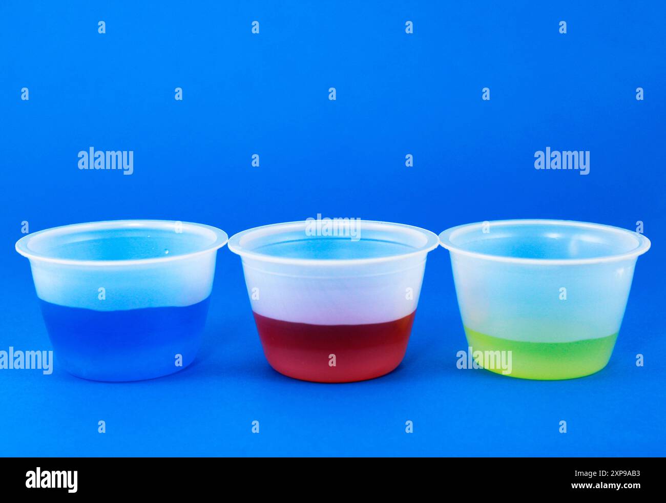 Plastic containers with liquid of different colors Stock Photo - Alamy