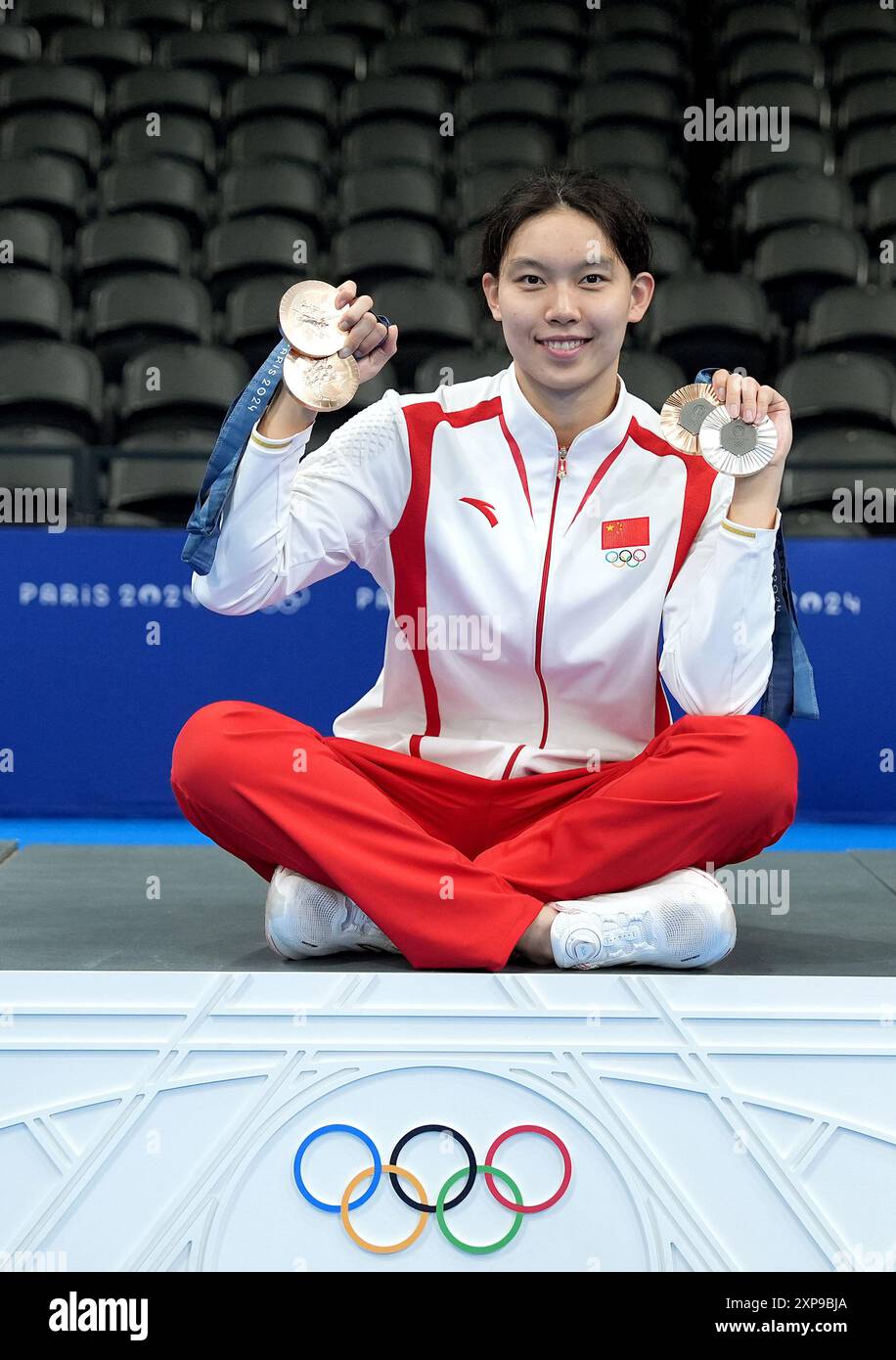 Paris, France. 4th Aug, 2024. Chinese swimming athlete Yang Junxuan shows medals at Paris 2024 ...