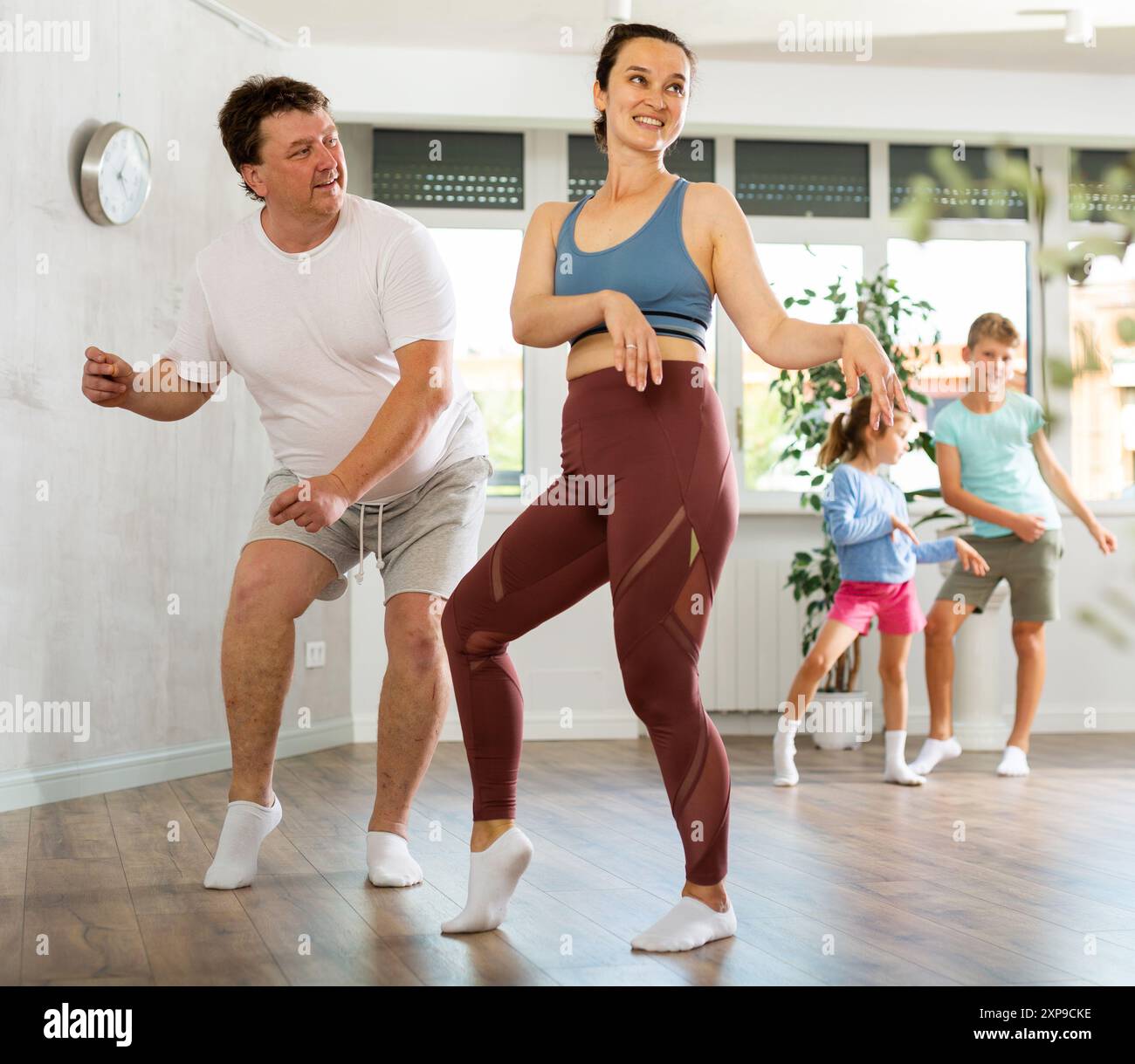 Family with two children dancing in studio Stock Photo - Alamy