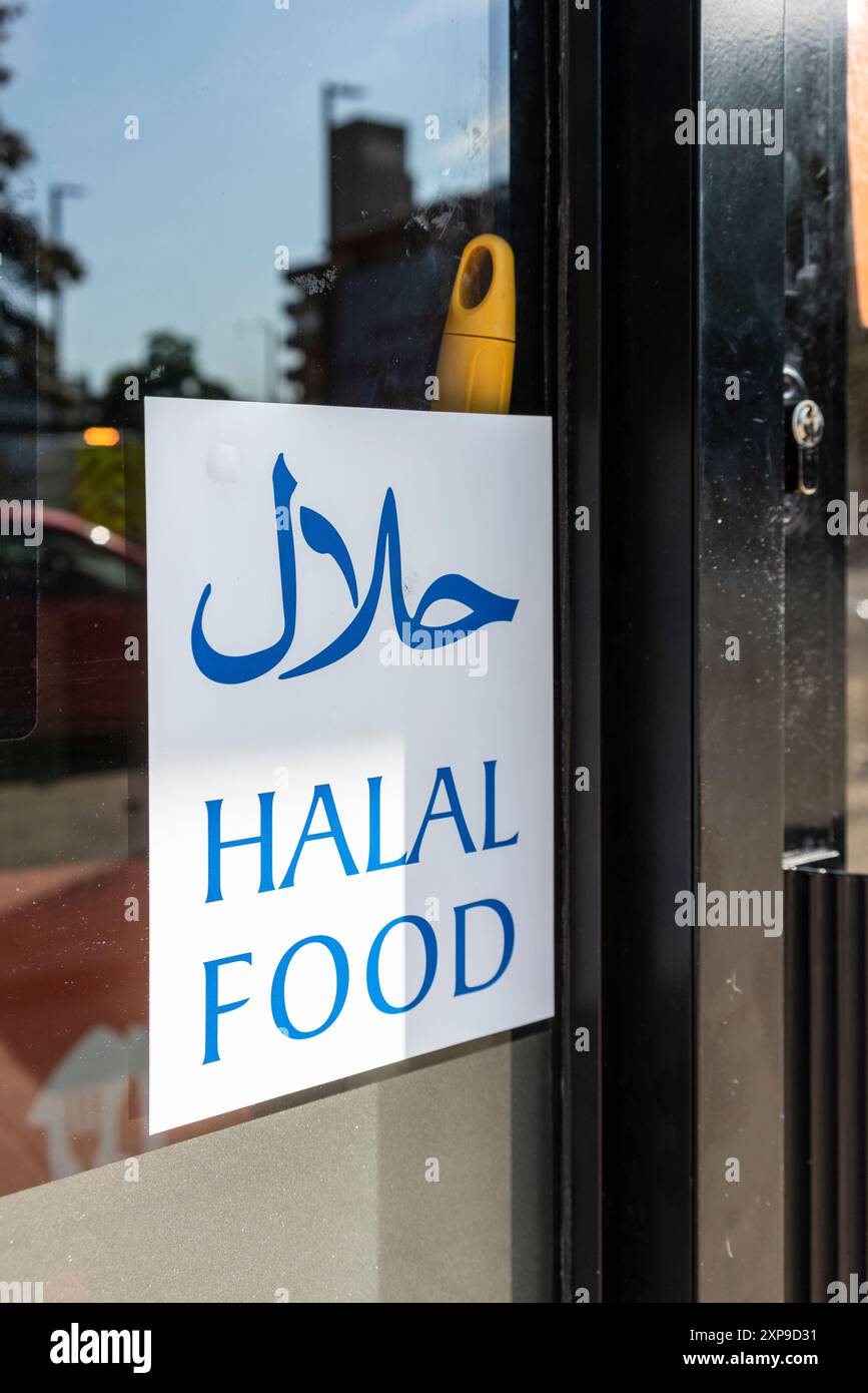 Halal Food sign written in Arabic and English displayed in the window ...