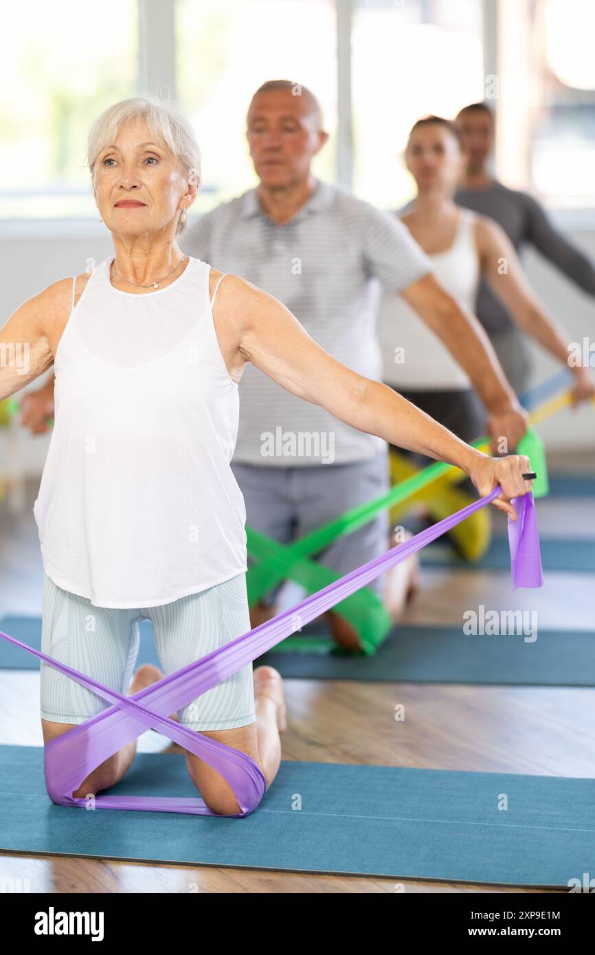 Elderly woman exercises with pilates band Stock Photo - Alamy