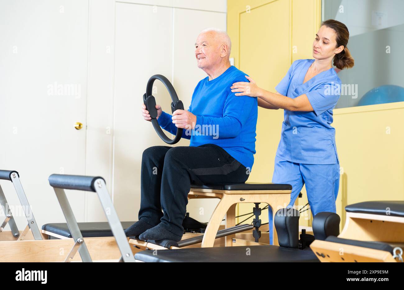 Healthcare professional helps an elderly man restore health with ...
