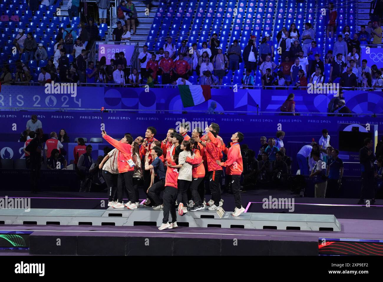 Japan fencing team members take a selfie on the podium of men's team ...