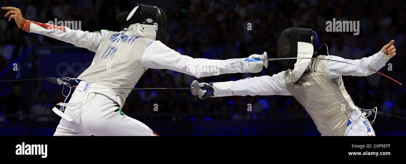 An Italy's team member (L) and a Japan's member compete during the men ...