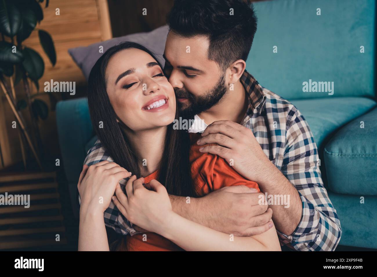 Photo of happy young couple hugging kiss cheek move new place enjoy ...