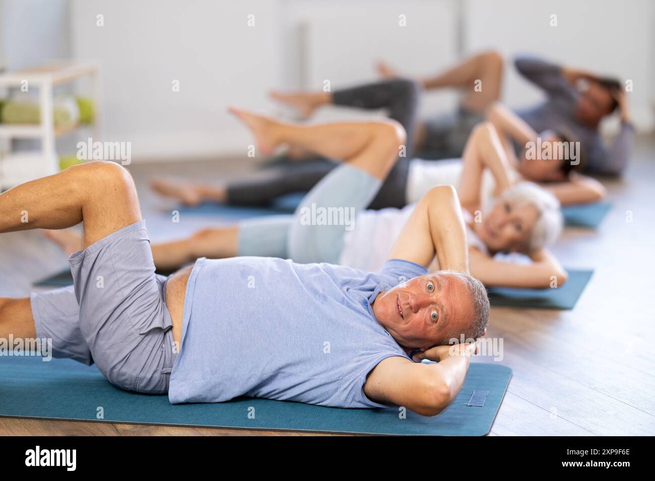 Pensioners doing fitness in group classes - doing exercises for ...