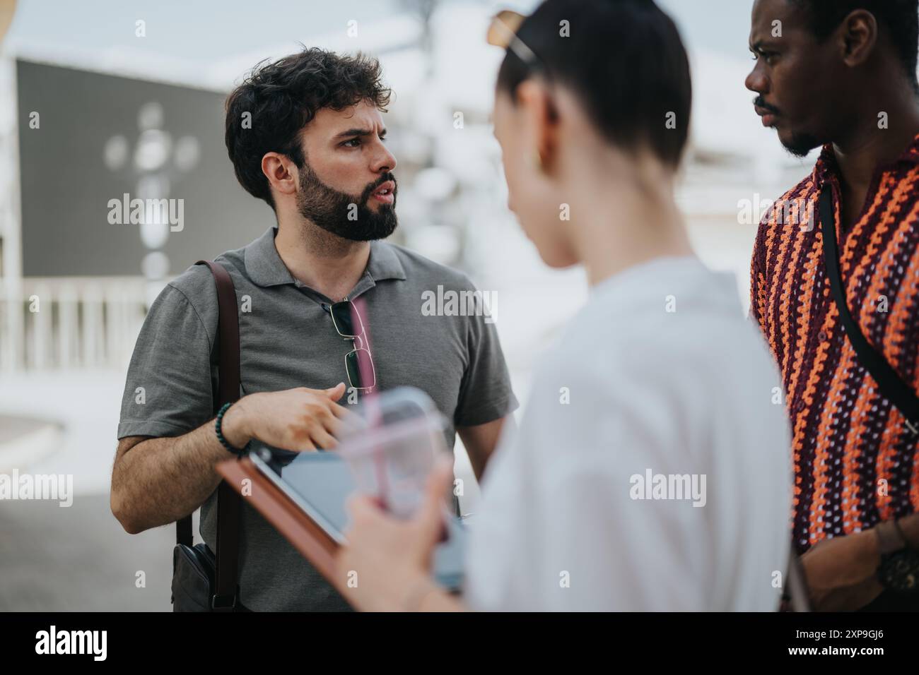 Diverse group of young professionals having an outdoor discussion Stock ...