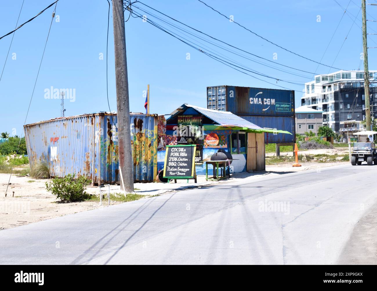 A roadside food stall offering traditional dishes like oxtail and jerk ...
