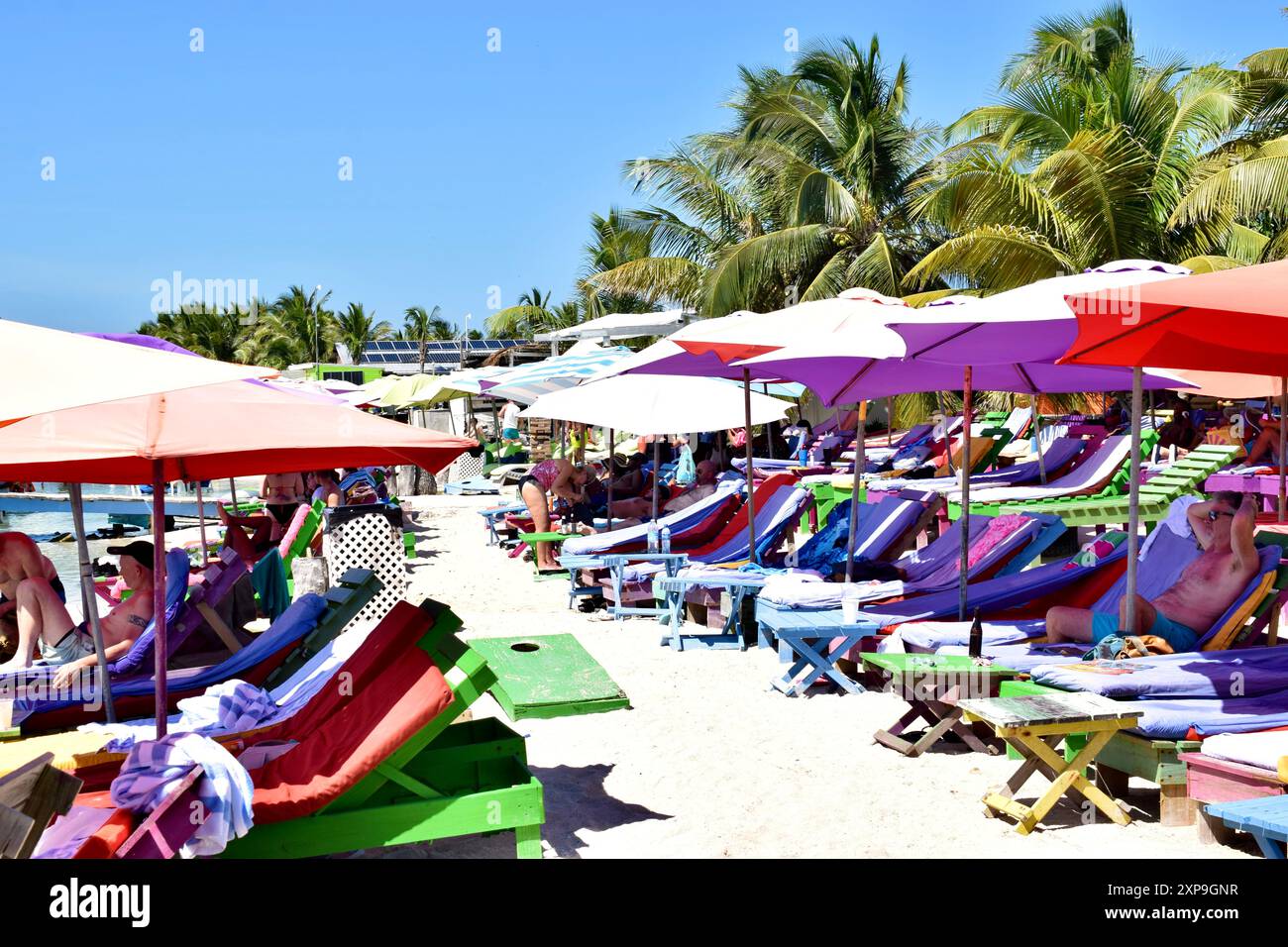 Tourists enjoying Secret Beach in San Pedro, Belize. People relaxing in ...