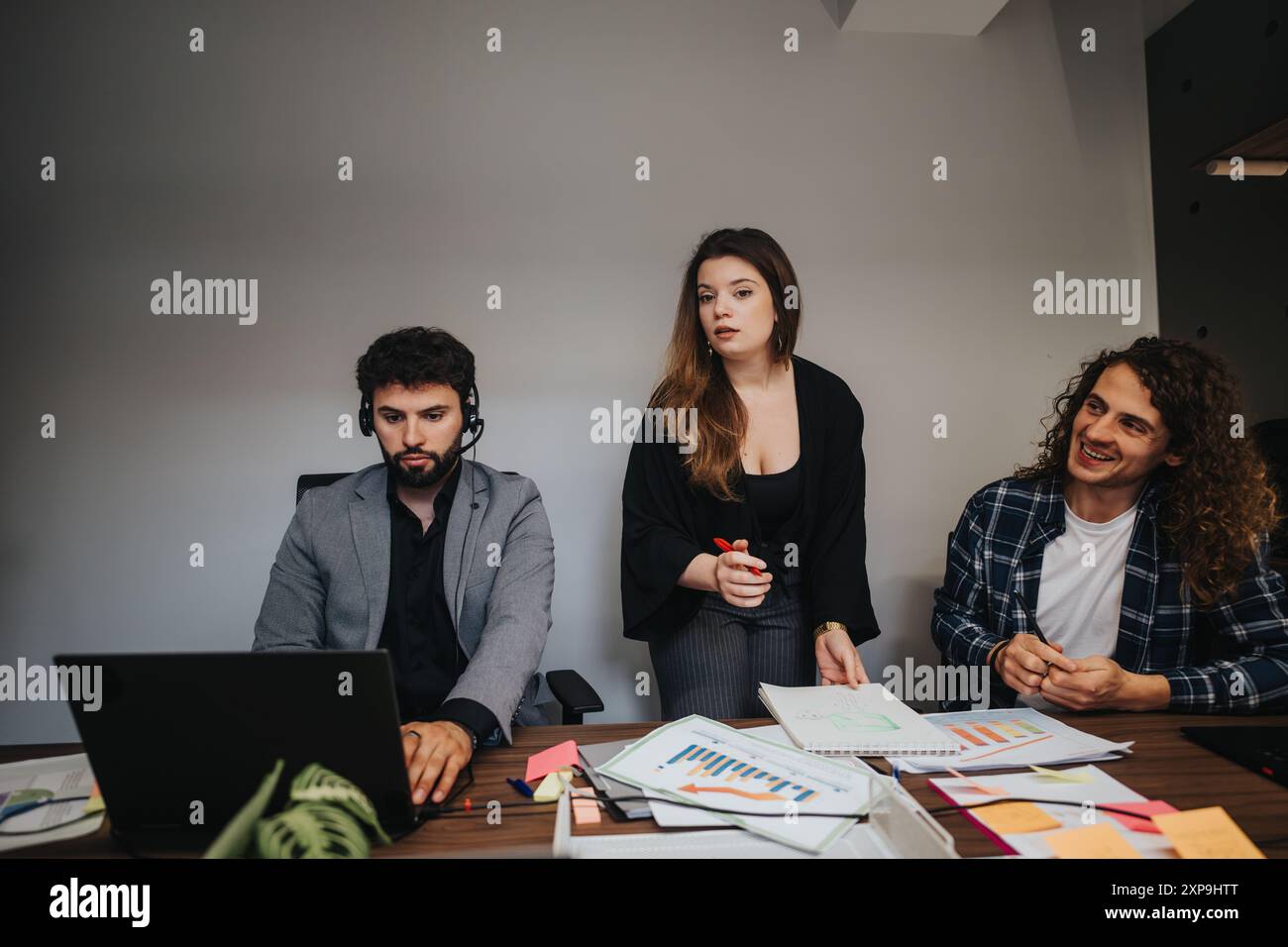 Professional team evaluating business charts in modern office setup ...