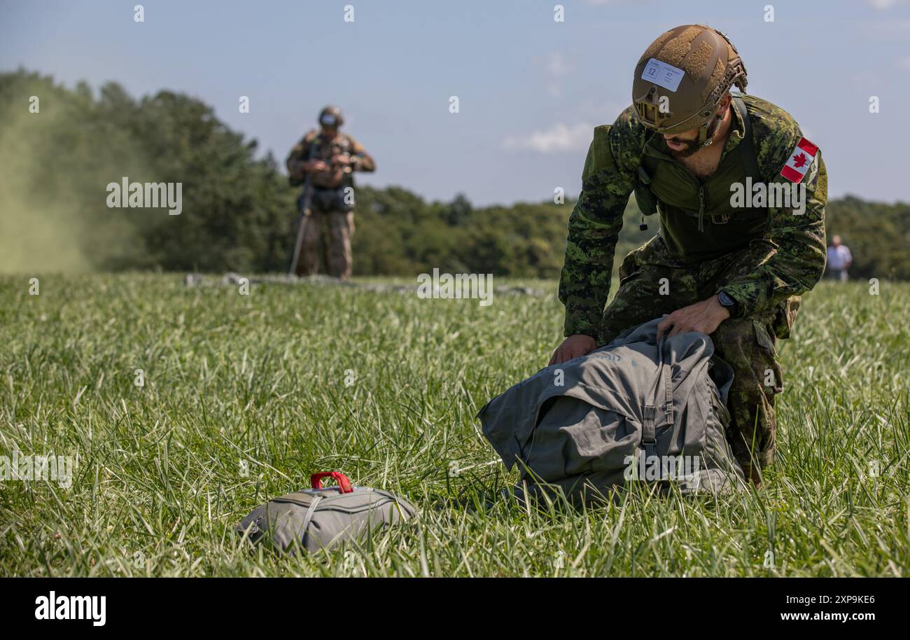 A Canadian Paratrooper packs up his MC-6 Parachute on the drop zone ...