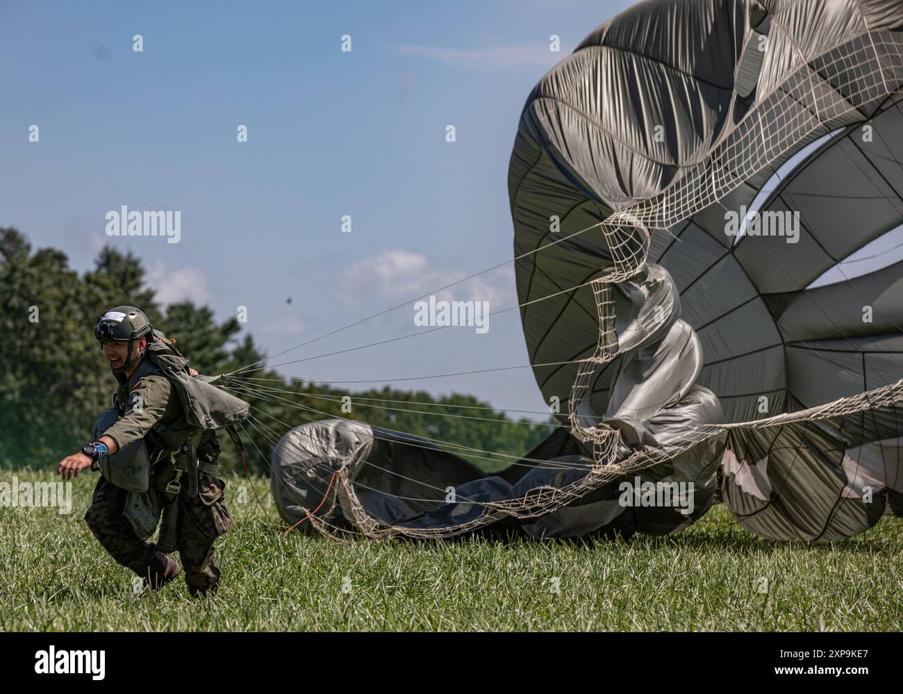 A Polish Paratrooper drags his MC-6 Parachute as he runs towards the X ...