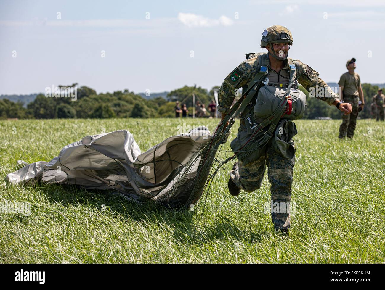 An Austrian Paratrooper drags his MC-6 Parachute as he runs towards the ...