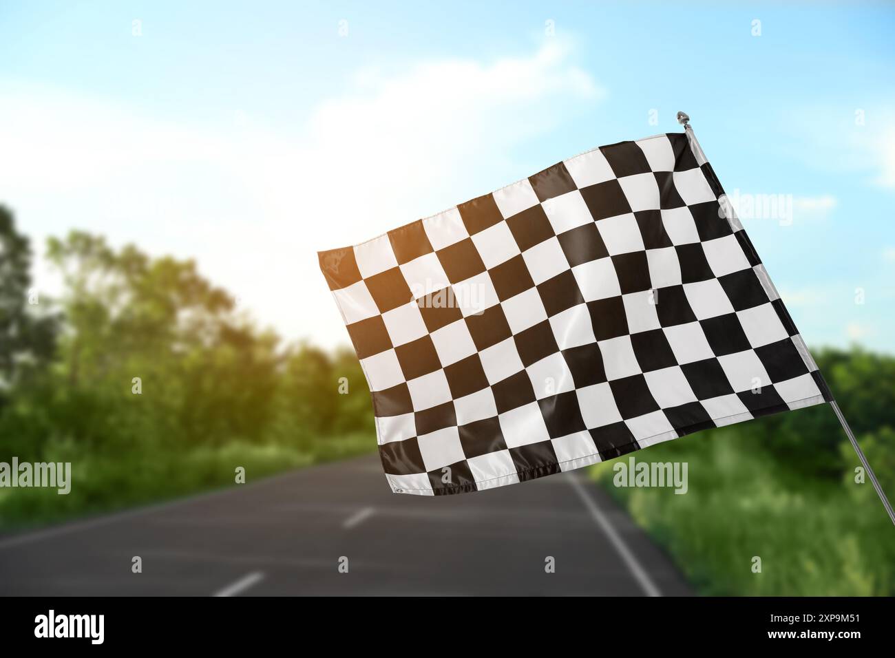 Checkered finish flag and asphalt racing track outdoors Stock Photo - Alamy