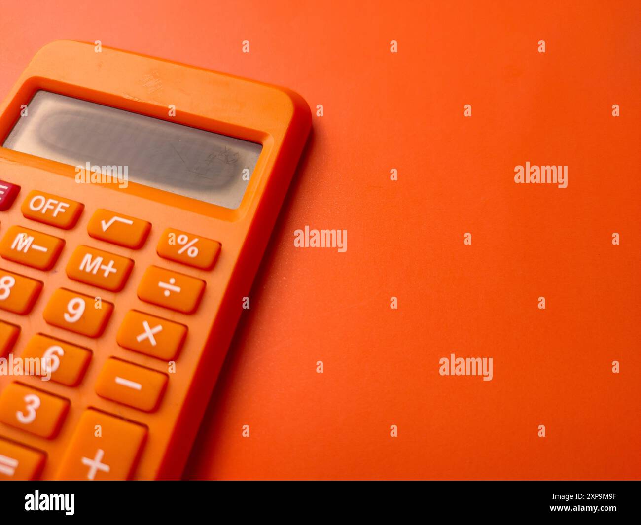 Closeup orange calculator on a orange background with copy and text space Stock Photo - Alamy