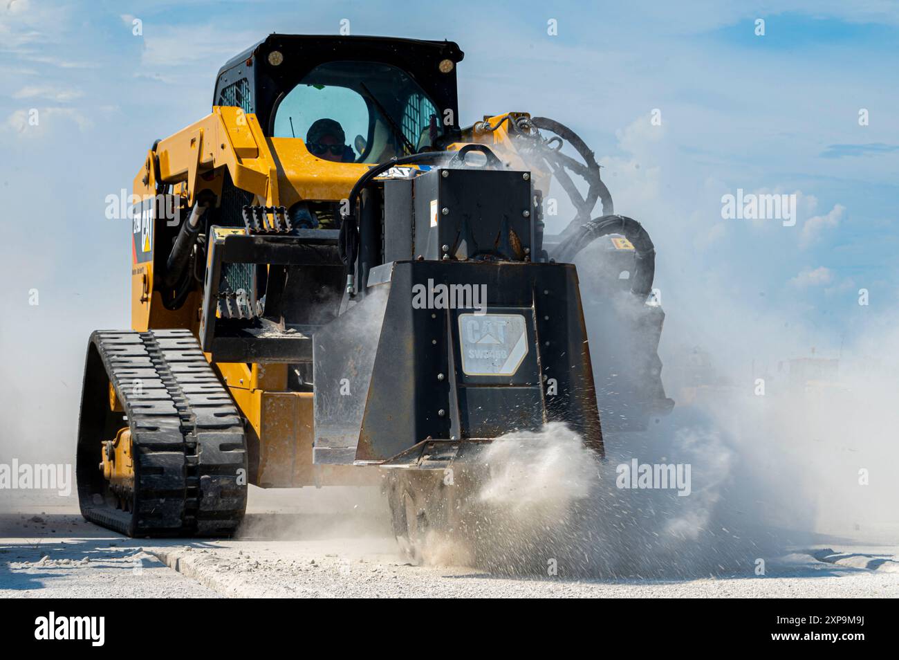 A U.S. Airman practices operating a Compact Track Loader with a ...