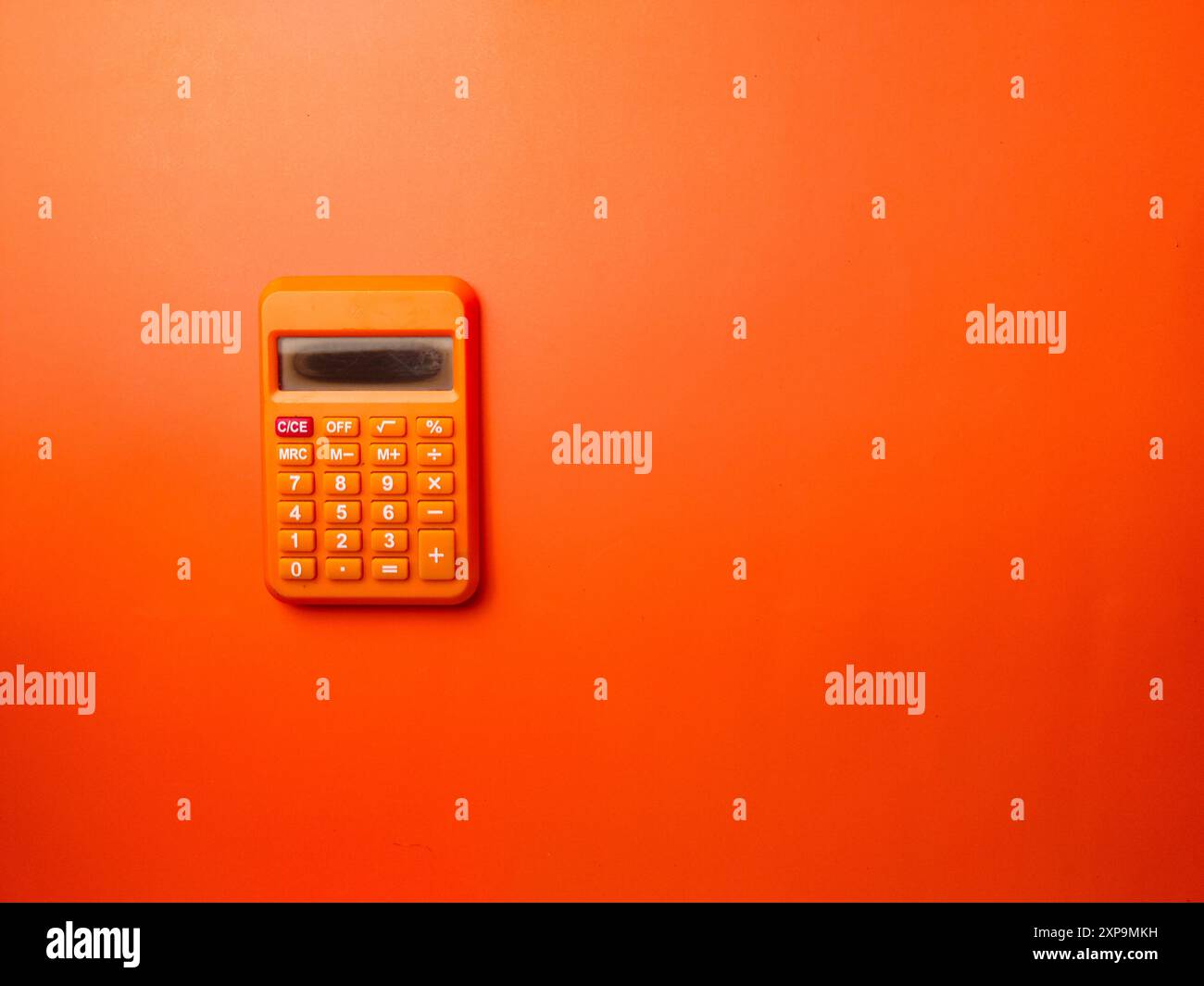 Top view orange calculator on a orange background with copy and text ...