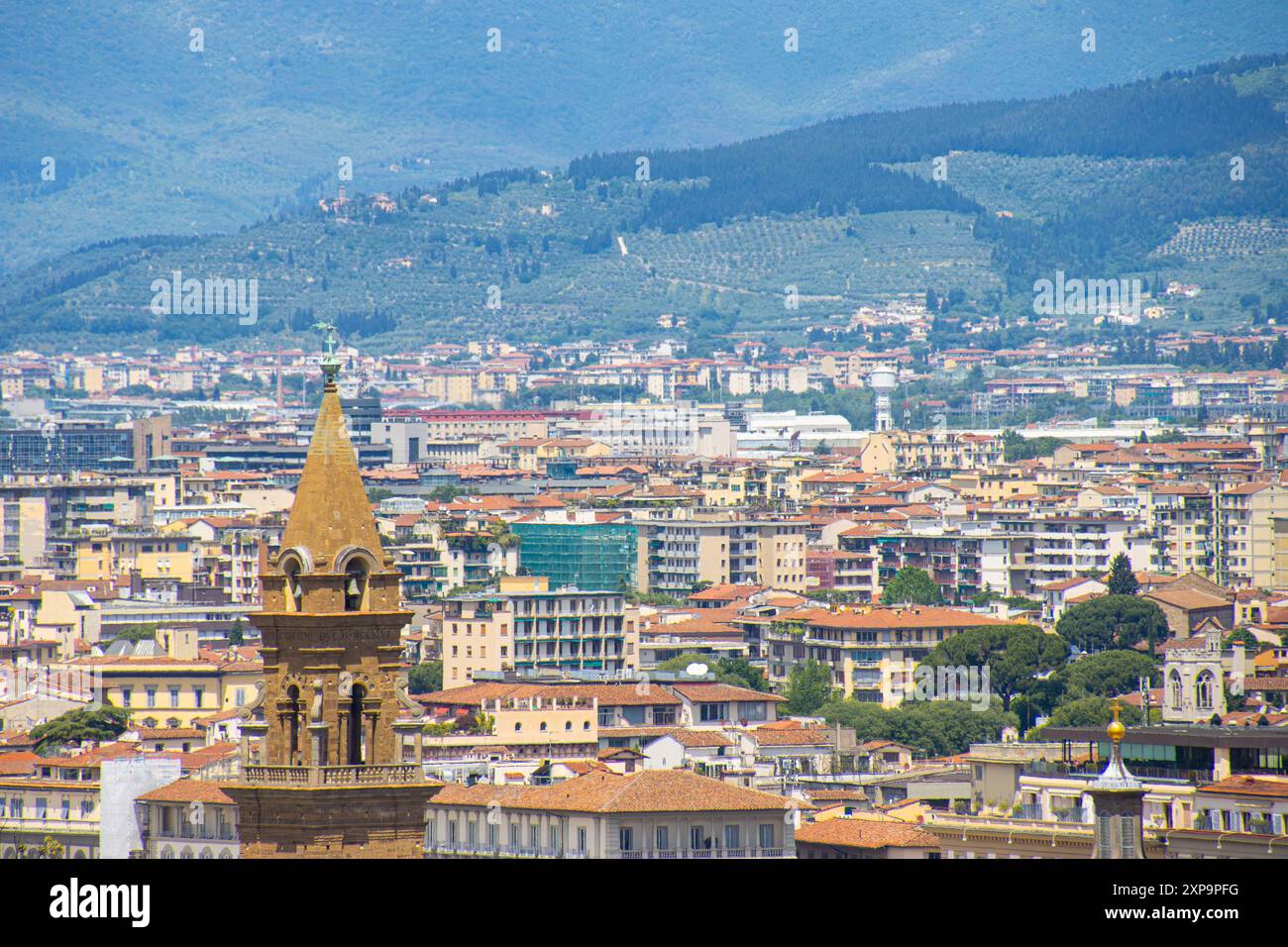 Tower of Badia Fiorentina Abbey surrounded by buildings in Florence ...