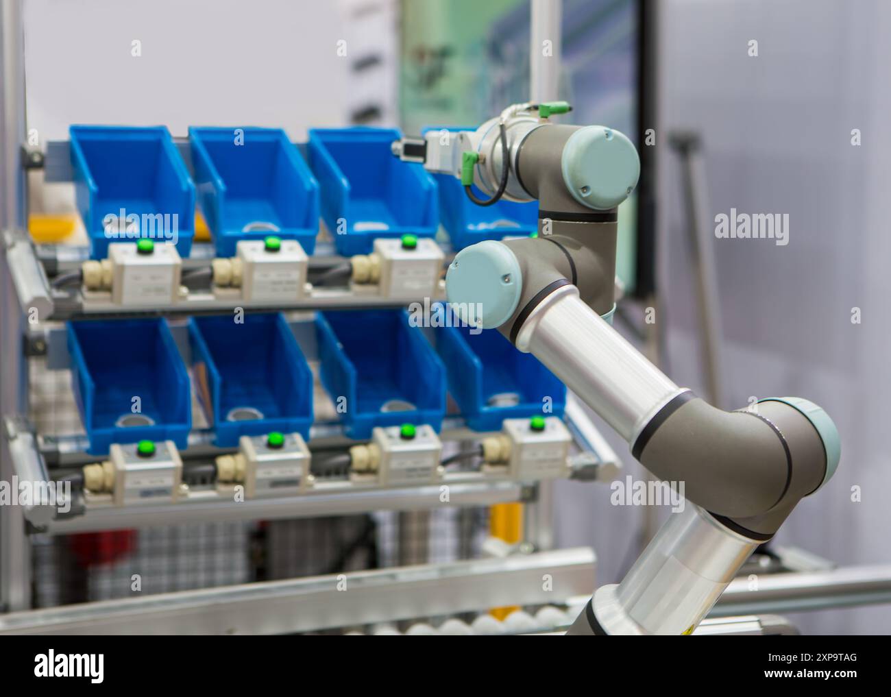 Smart warehouse. Robots pick up parts from plastic bin rack Stock Photo ...