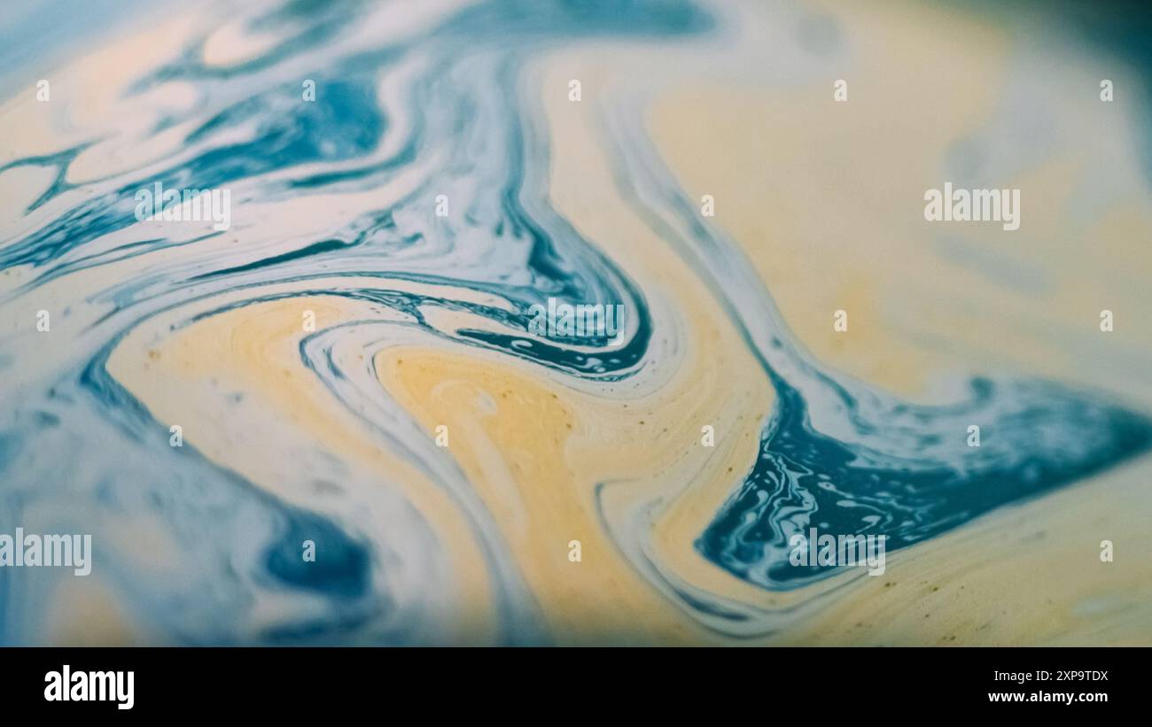 Foam fluid spill. Paint flow. Defocused blue yellow color acrylic dye ...