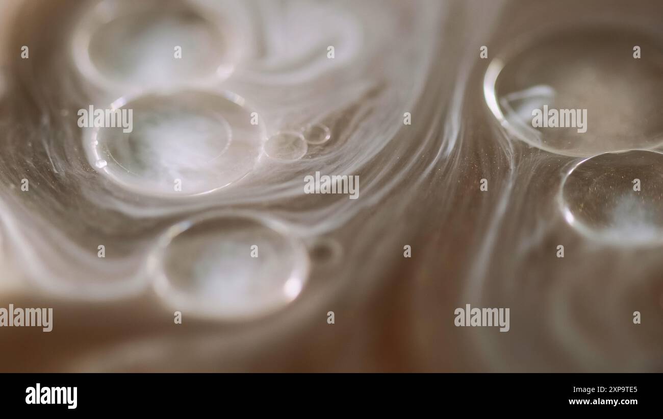 Oil fluid. Glitter mist. Defocused white bronze beige color transparent sparkling bubbles ...