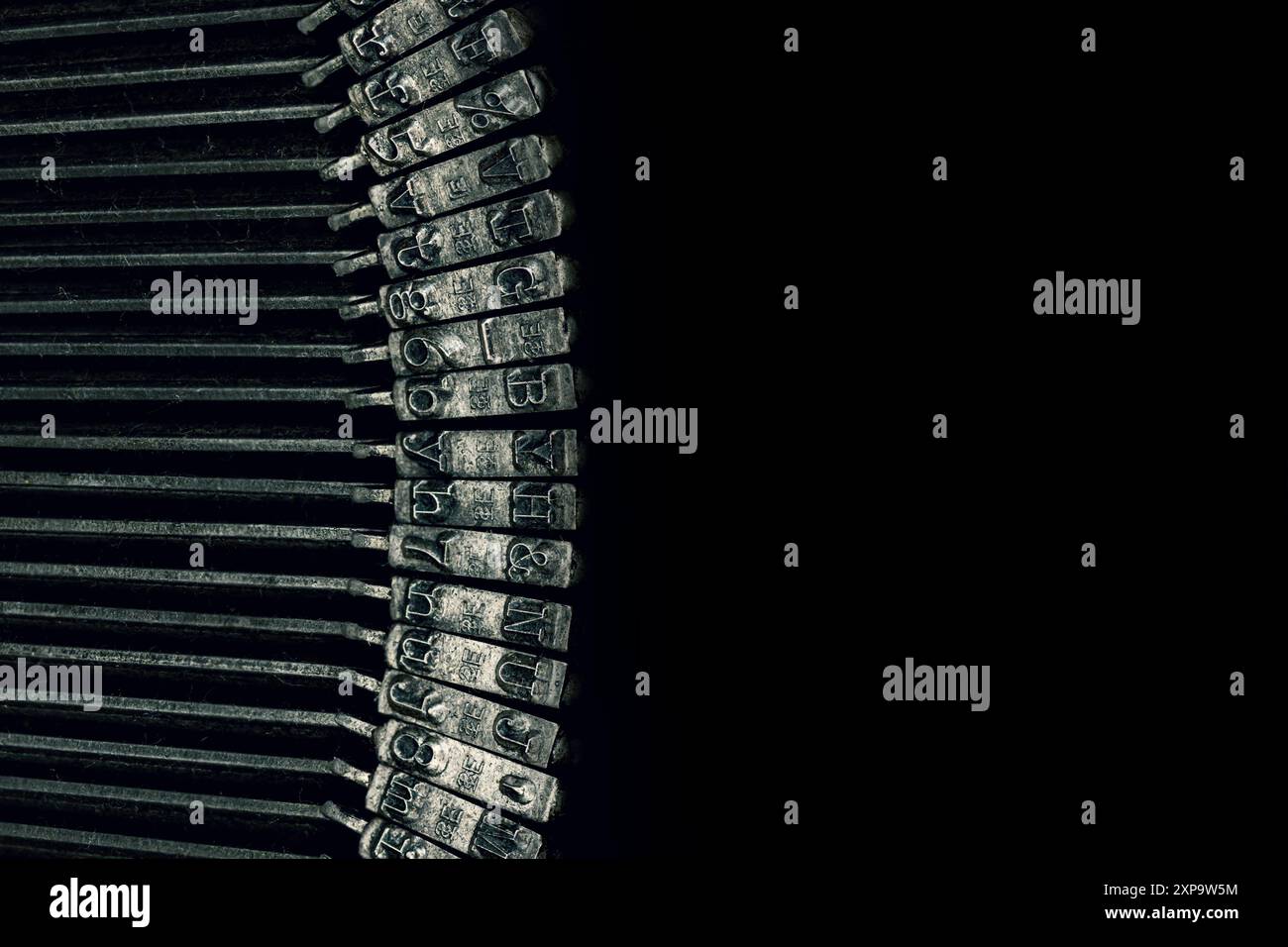 Macro photograph of typewriter hammers on a black background with room ...