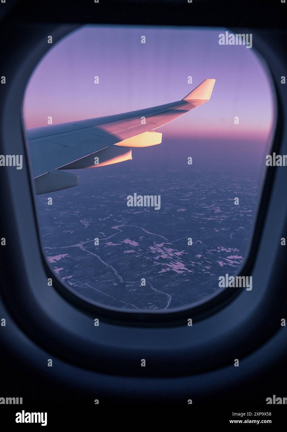 Looking out the window of a passenger flight in winter over eastern ...
