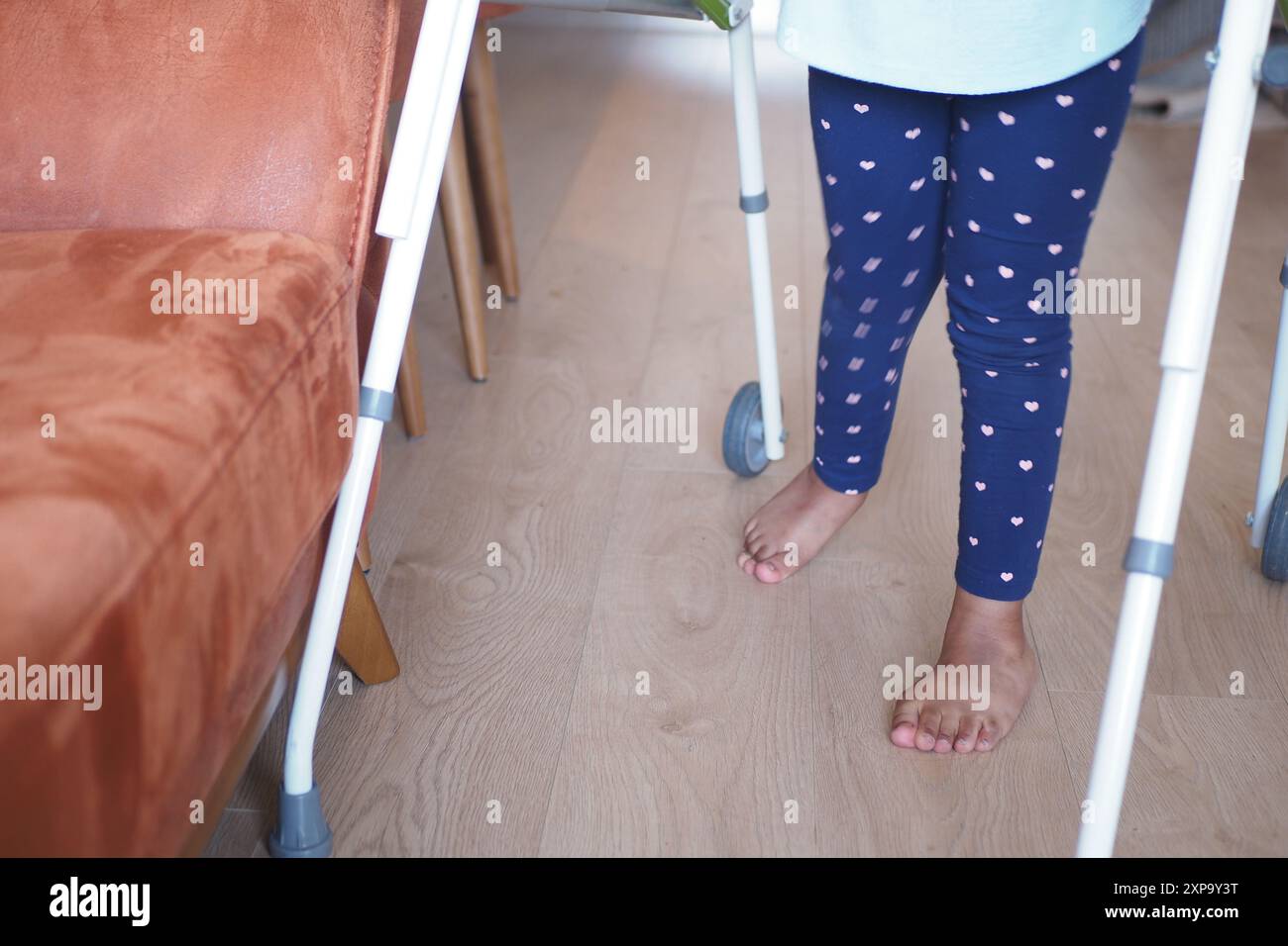 child with walking frame indoor Stock Photo - Alamy