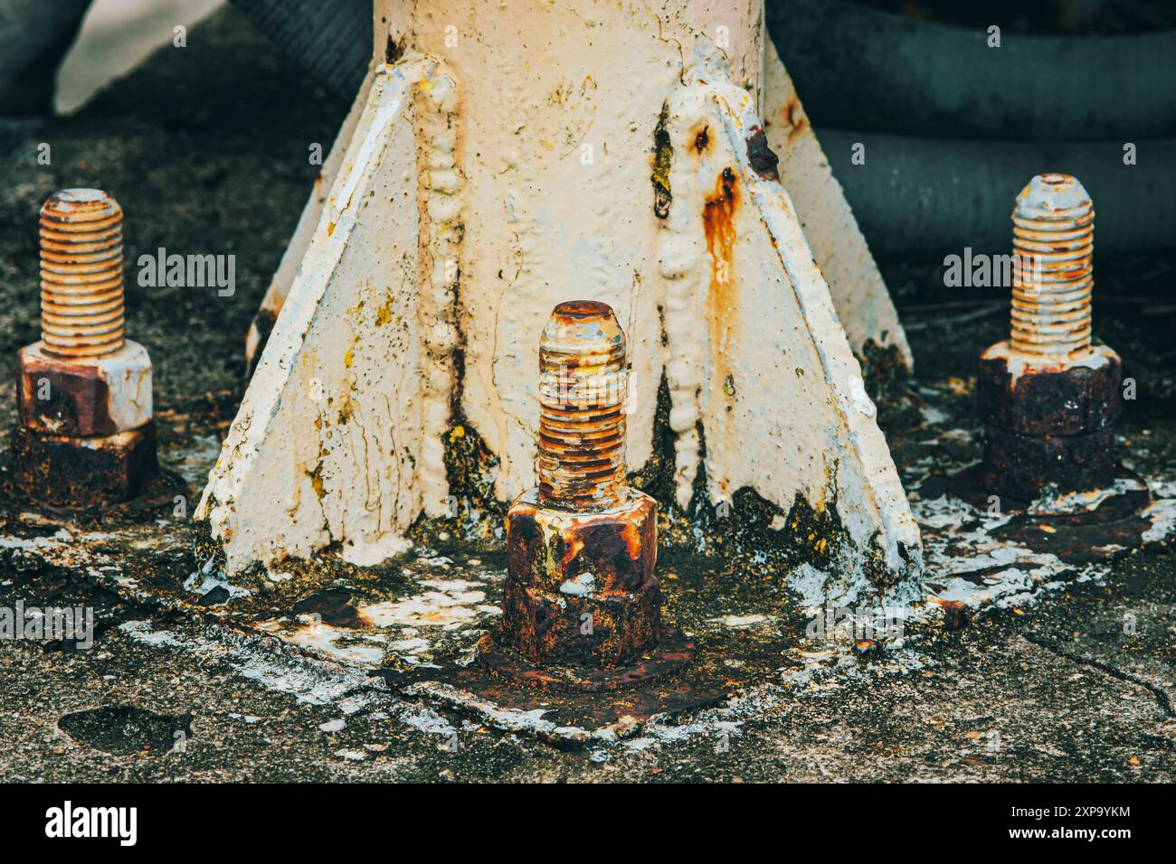 Rusty bolts holding a metal construction are showing corrosion, a ...
