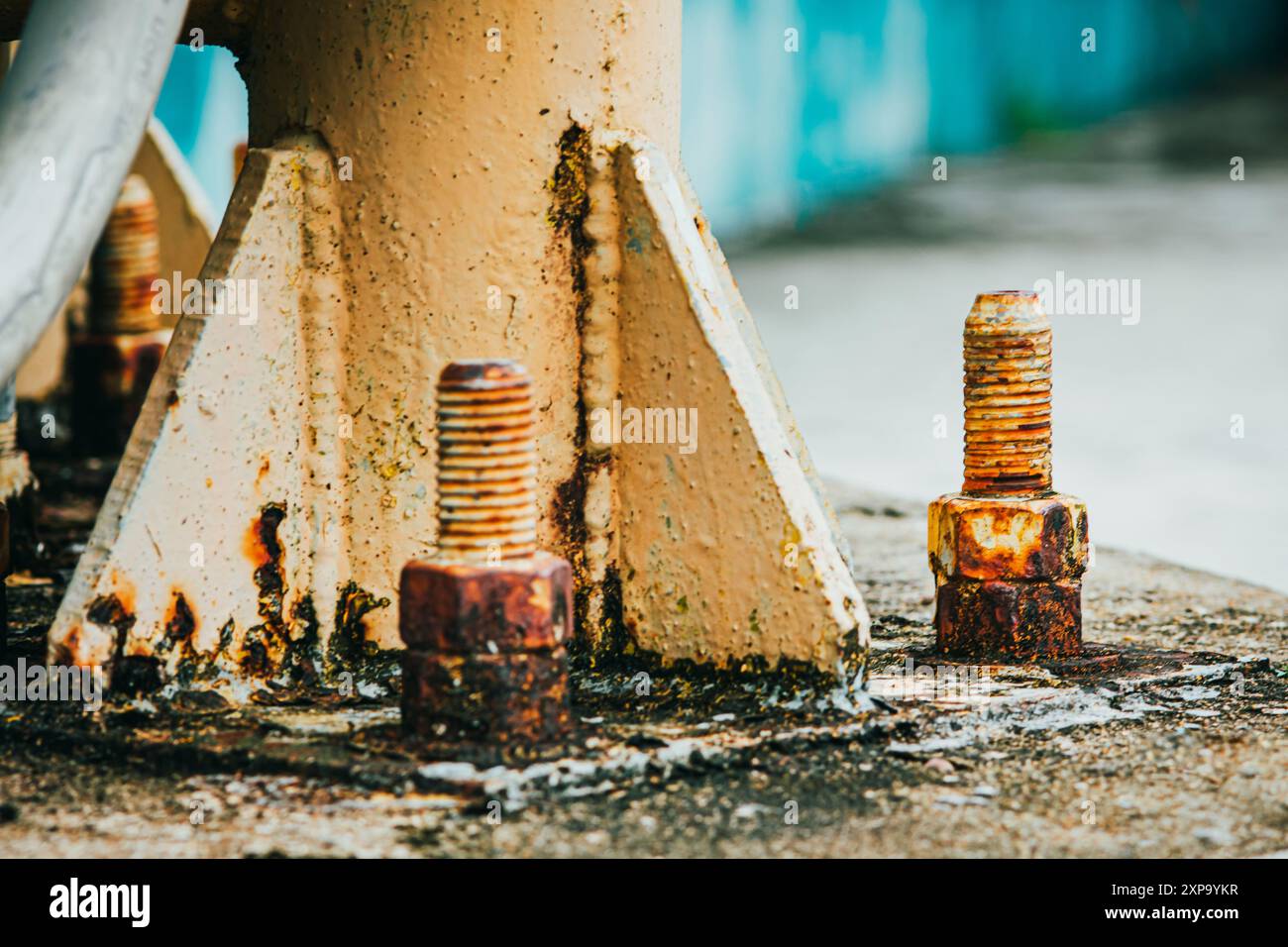 Rusty bolts holding a metal construction are showing corrosion, a ...