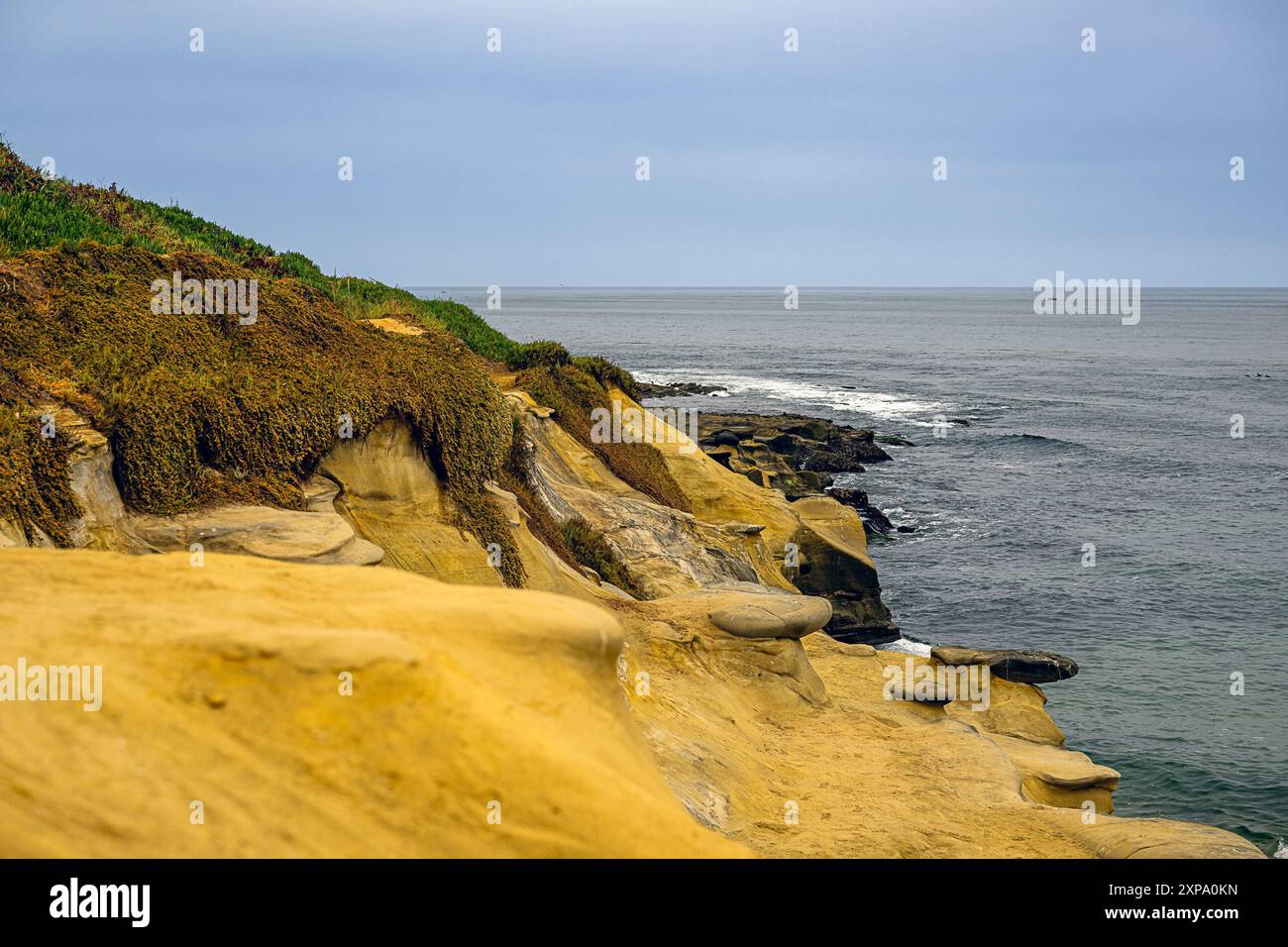 THE SMOOTH CLIFFS WITH VEGATATION AND TH EPACIFIC OCEANIN THE ...