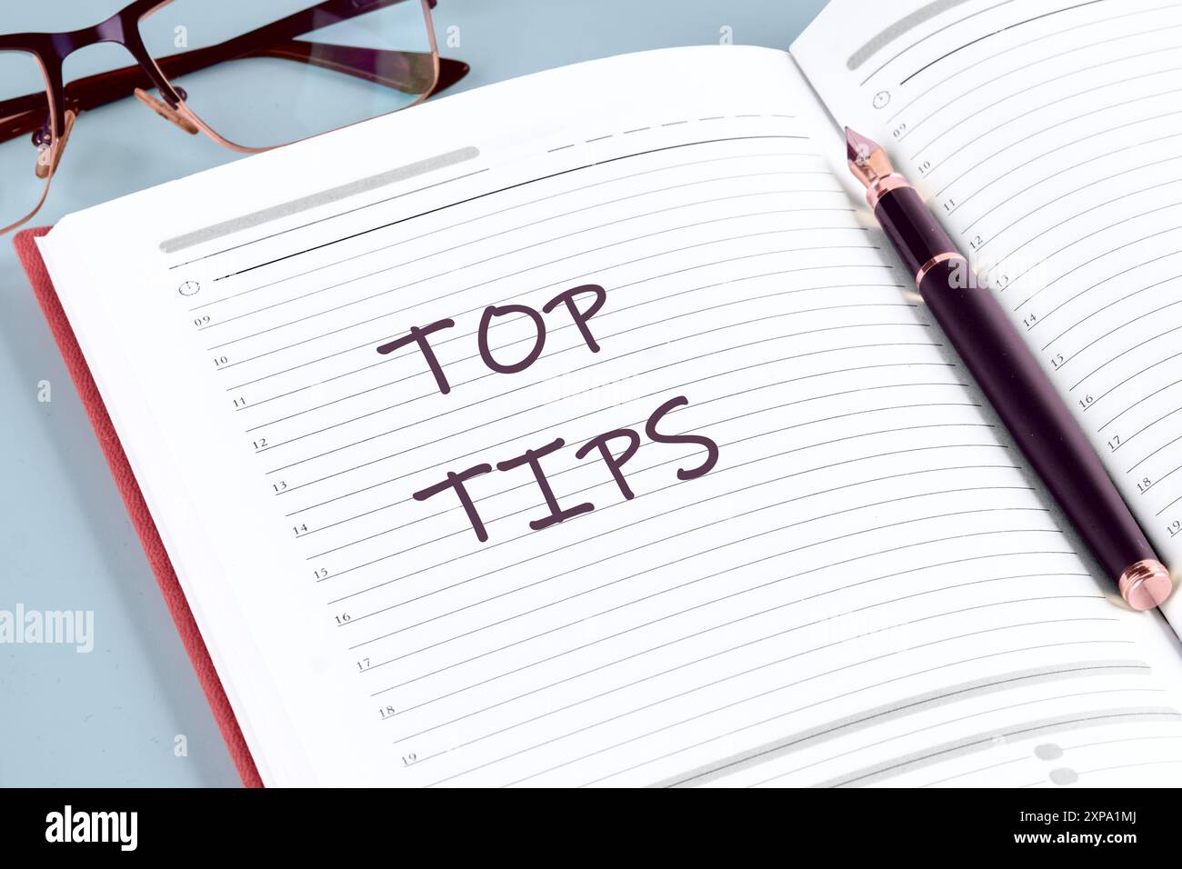 Top tips. Inscription TOP TIPS word in the notebook of a businessman ...